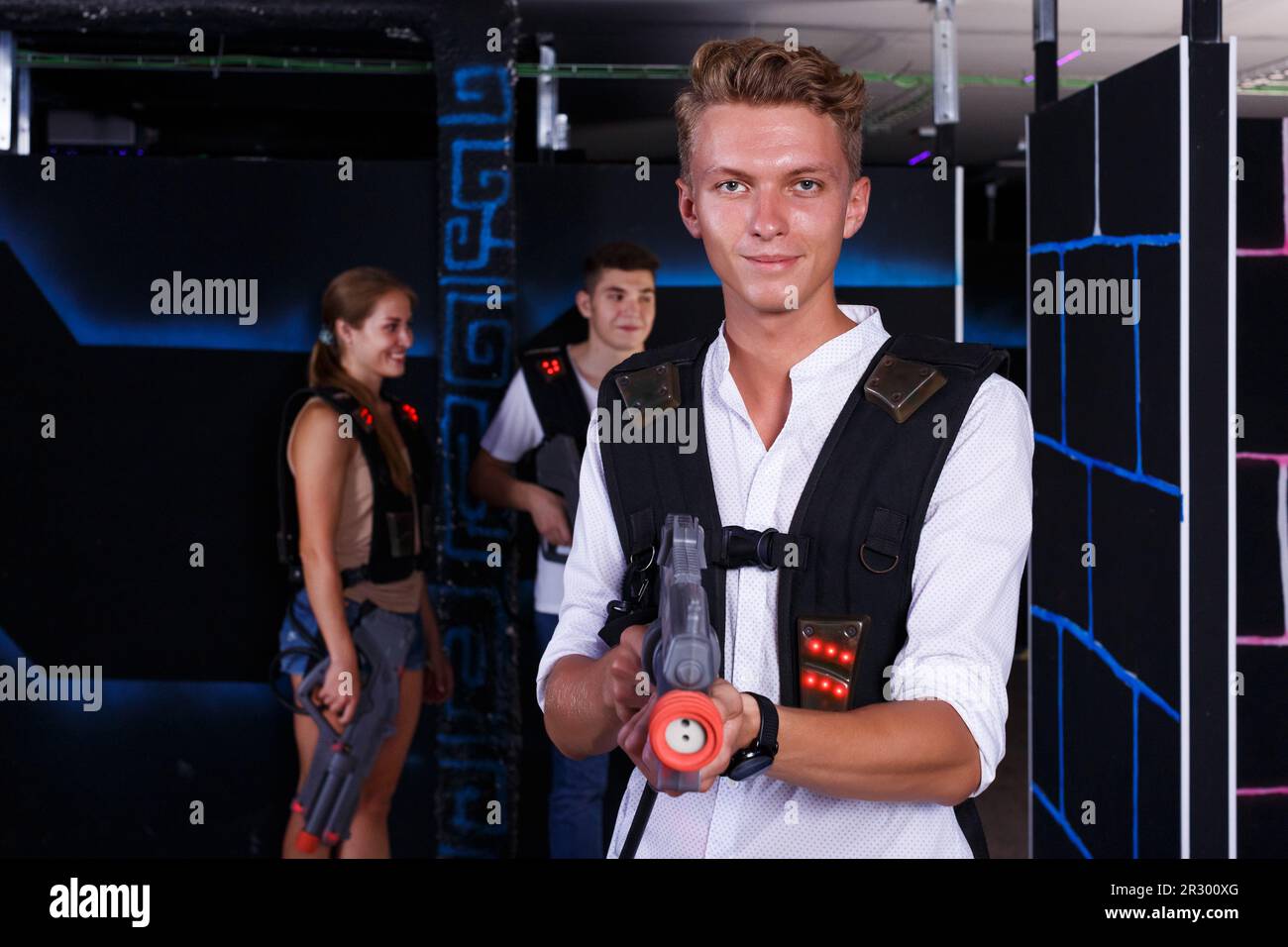 guy holding laser pistol playing laser tag game Stock Photo - Alamy