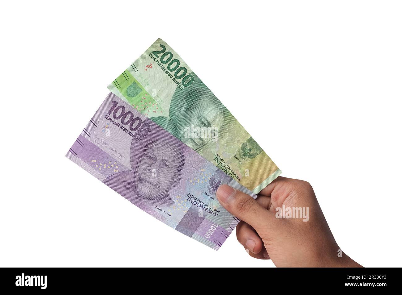 hand showing 10,000 and 20,000 rupiah isolated on white background ...
