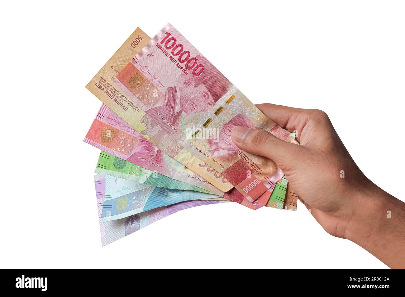 a man's hand shows rupiah money isolated on a white background, rupiah ...