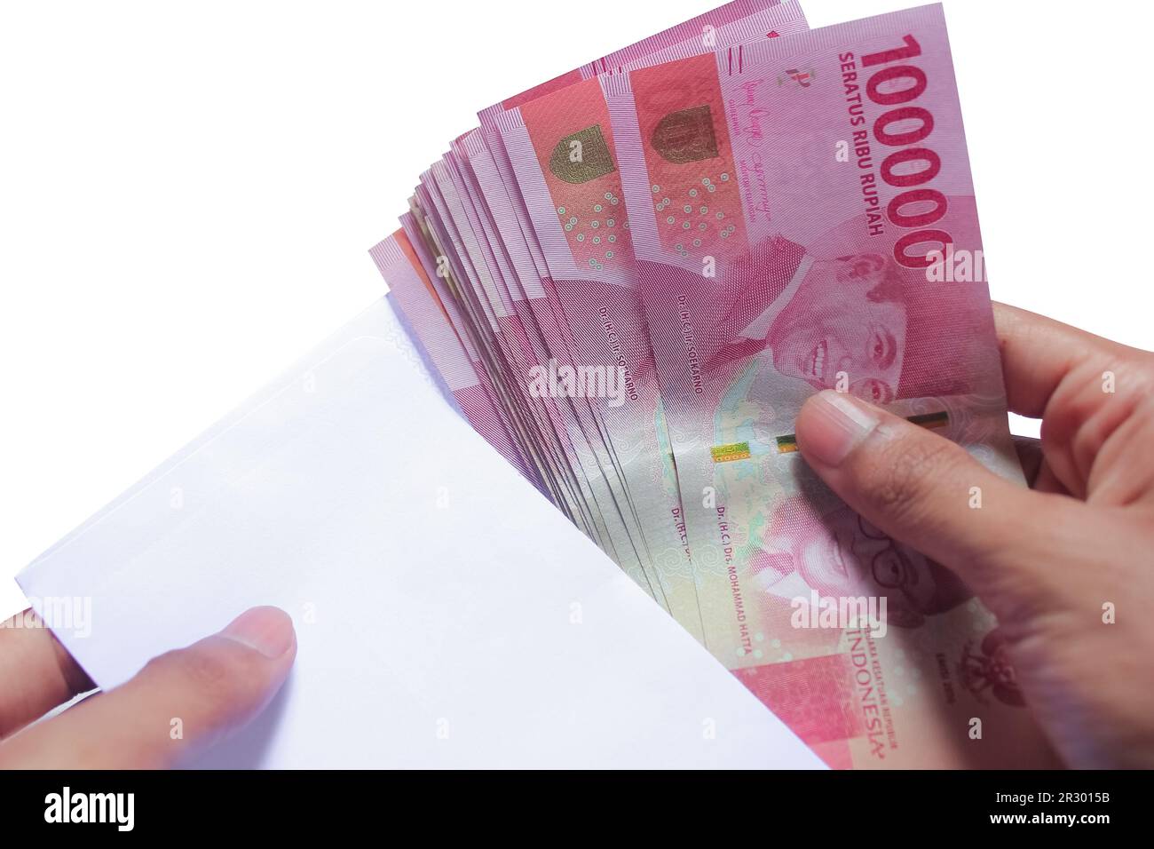 hand taking or putting money into an envelope, Indonesian currency ...