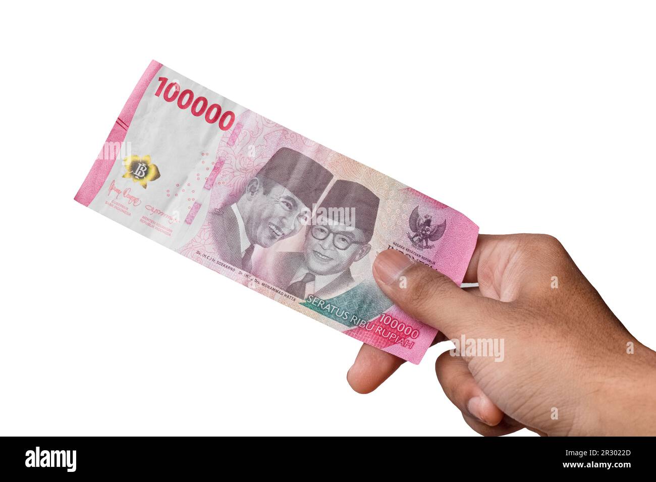 hand holding IDR 100,000 rupiah note isolated on white background ...