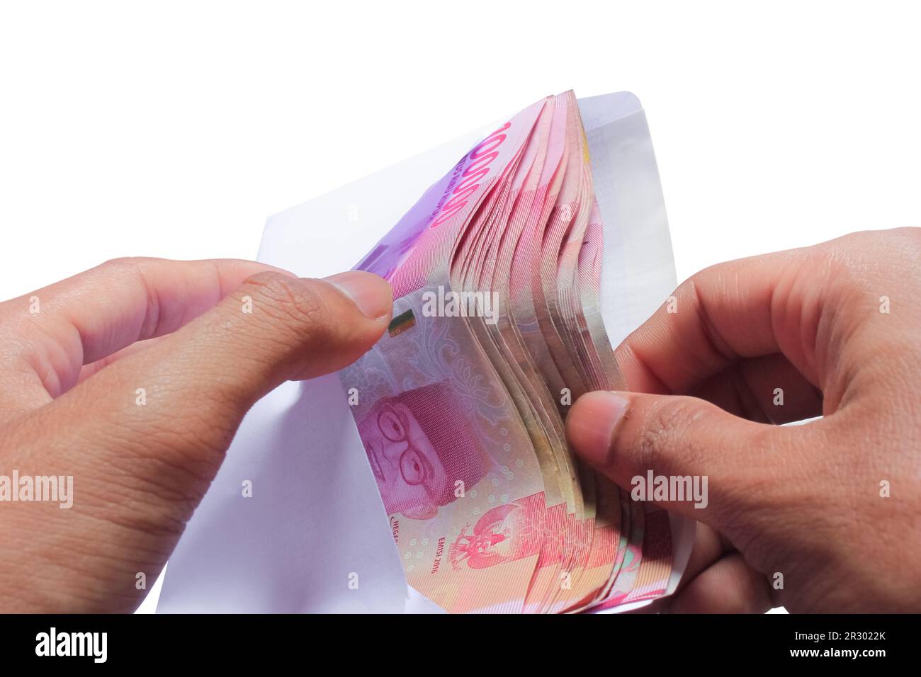 hand taking or putting money into an envelope, Indonesian currency ...