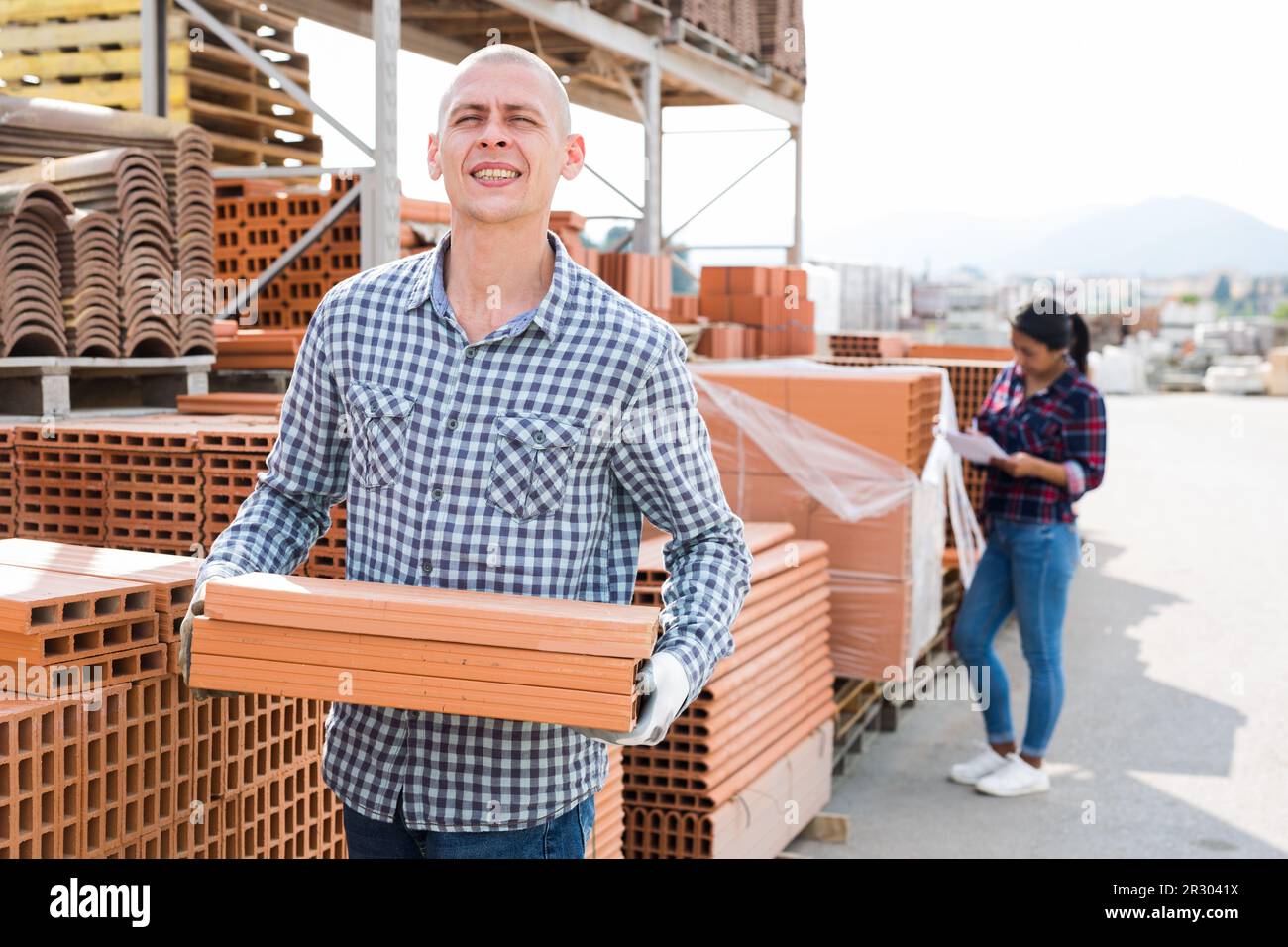 Builder is choosing bricks in building store Stock Photo - Alamy