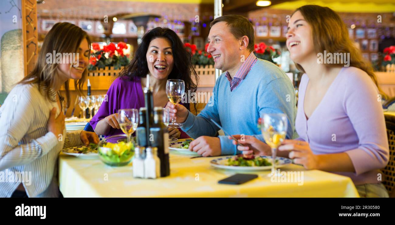 Happy adult people having fun in restaurant during dinner Stock Photo ...