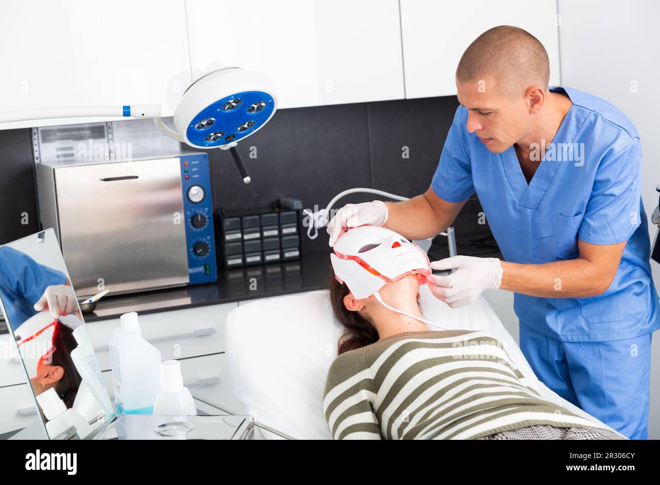Woman receiving LED facial mask light therapy Stock Photo - Alamy