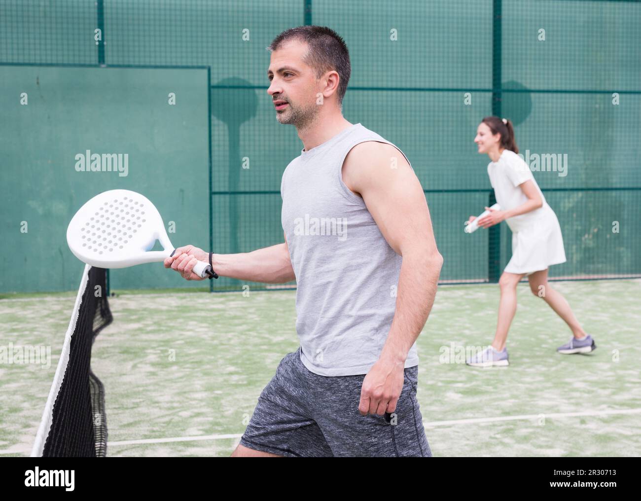 Doubles play in an outdoor paddle game court Stock Photo - Alamy