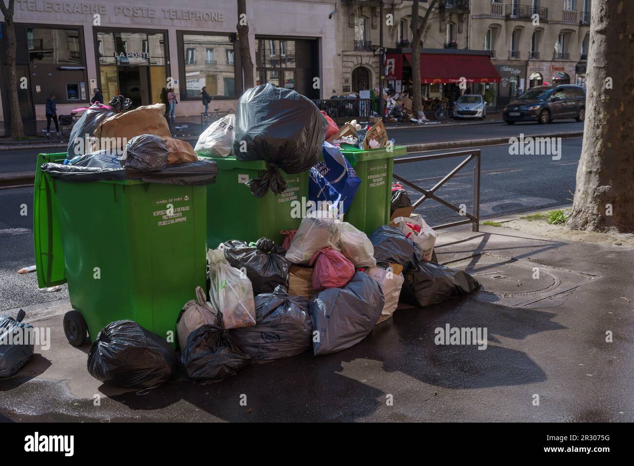 Overflowing garbage bins in the street of Paris, France during pension reform strike. March 24 ...