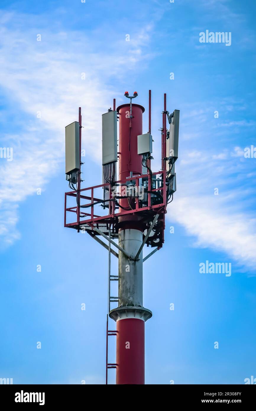 Cellular Telecommunication Tower with Radio Waves Visible Against Blue ...