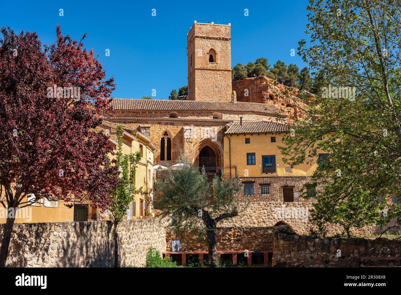 Church tower and medieval buildings of the pretty picturesque village ...