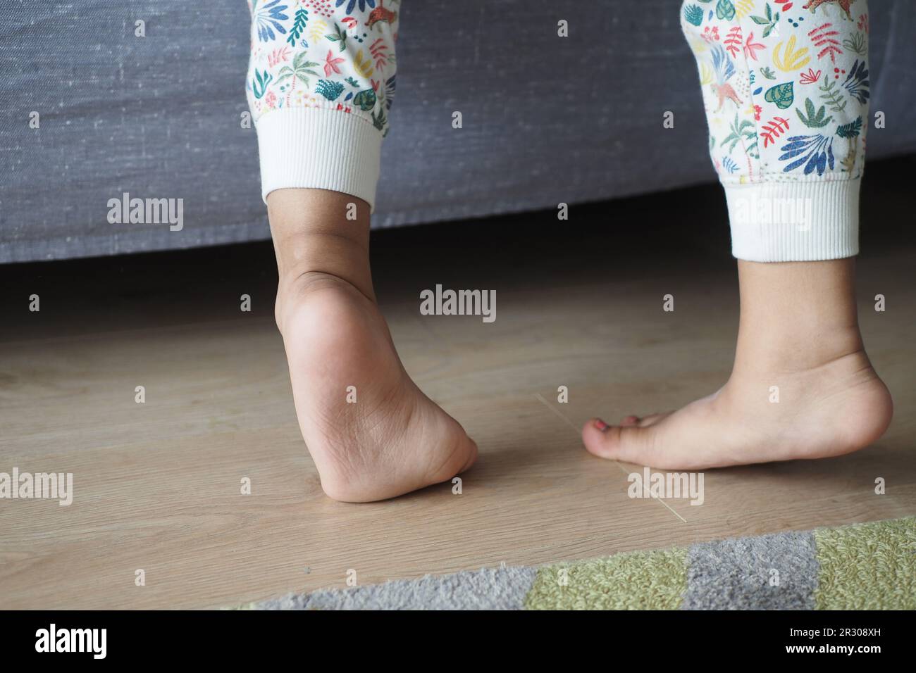 low angle view of A child walking on tiptoes Stock Photo - Alamy