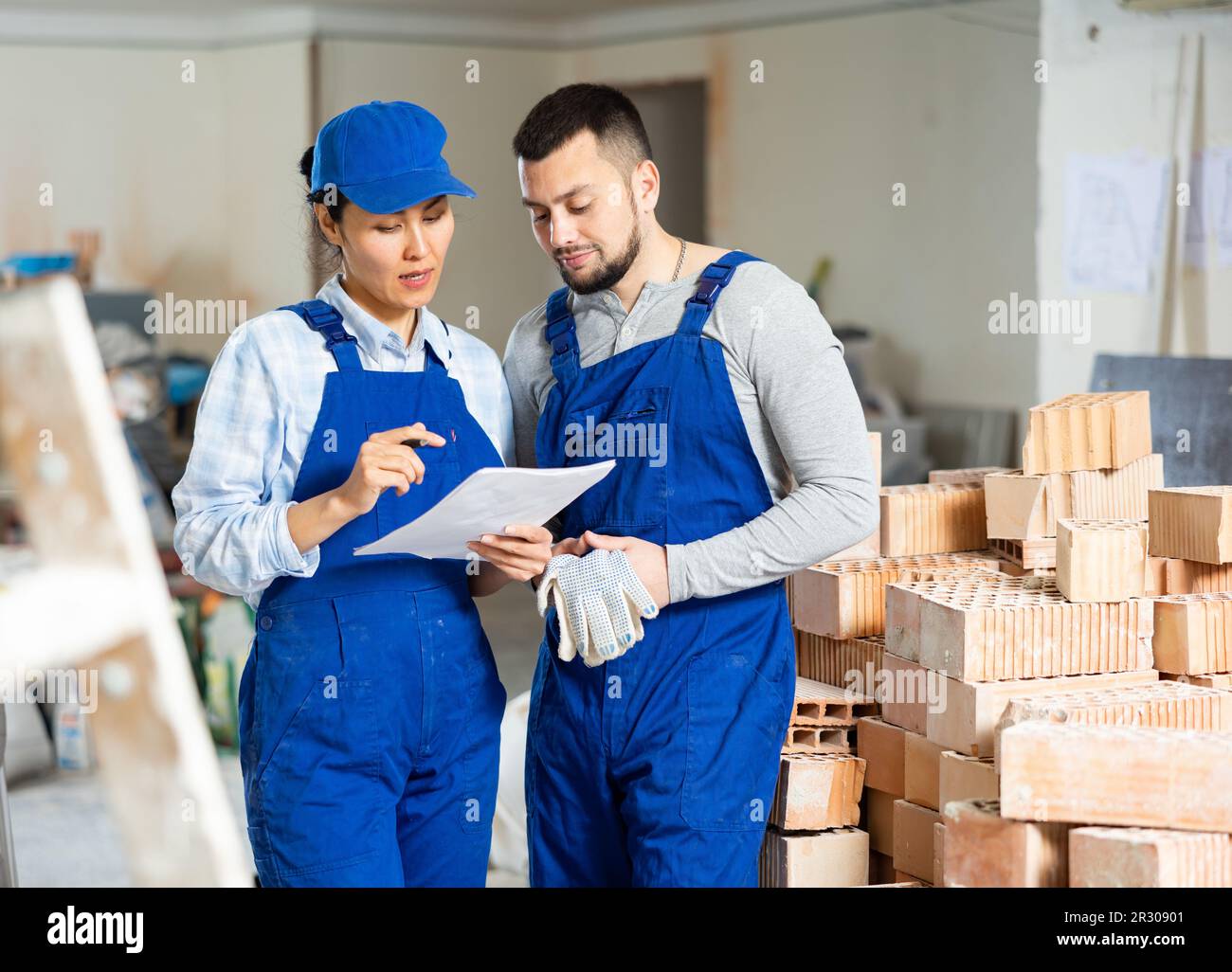 Builders determining scope of work in building under renovation Stock ...