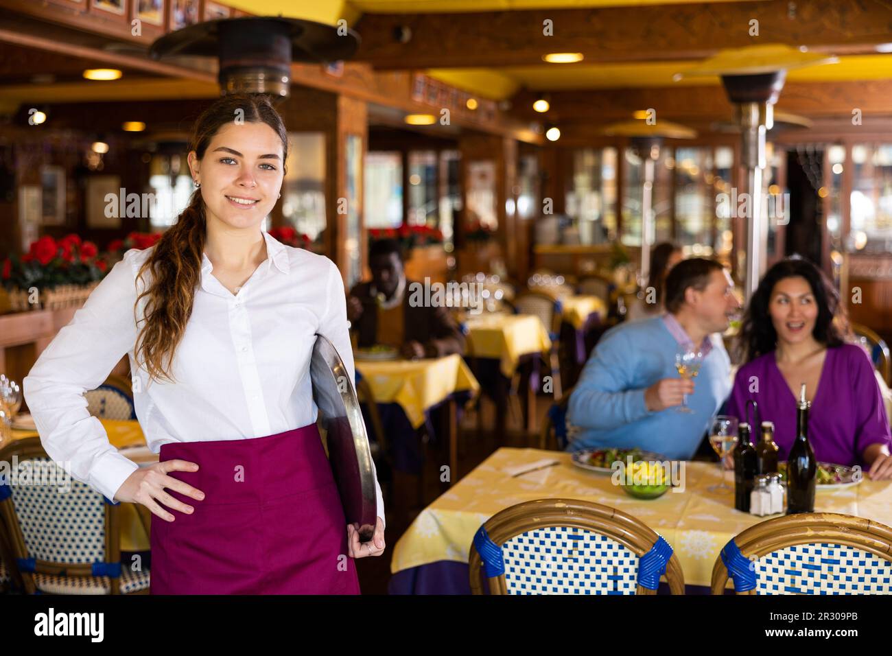 Portrait of young waitress standing in restaurant Stock Photo - Alamy