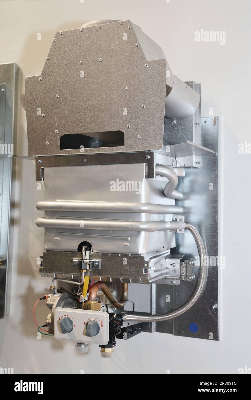 Close up on gas boiler installation on the wall in house boiler room ...