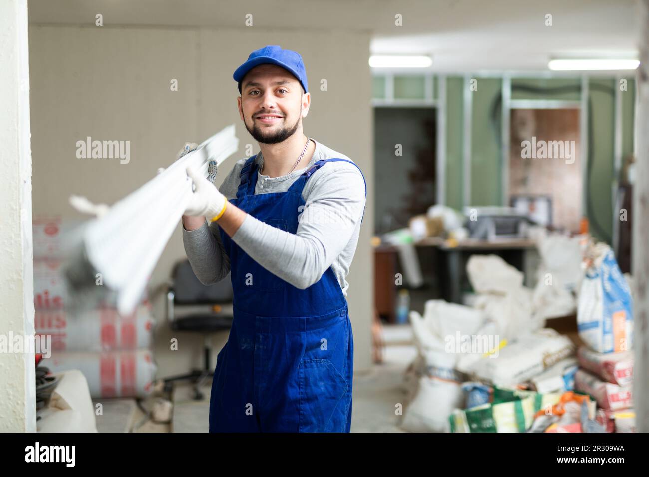 Worker carrying construction materials at renovating object Stock Photo ...
