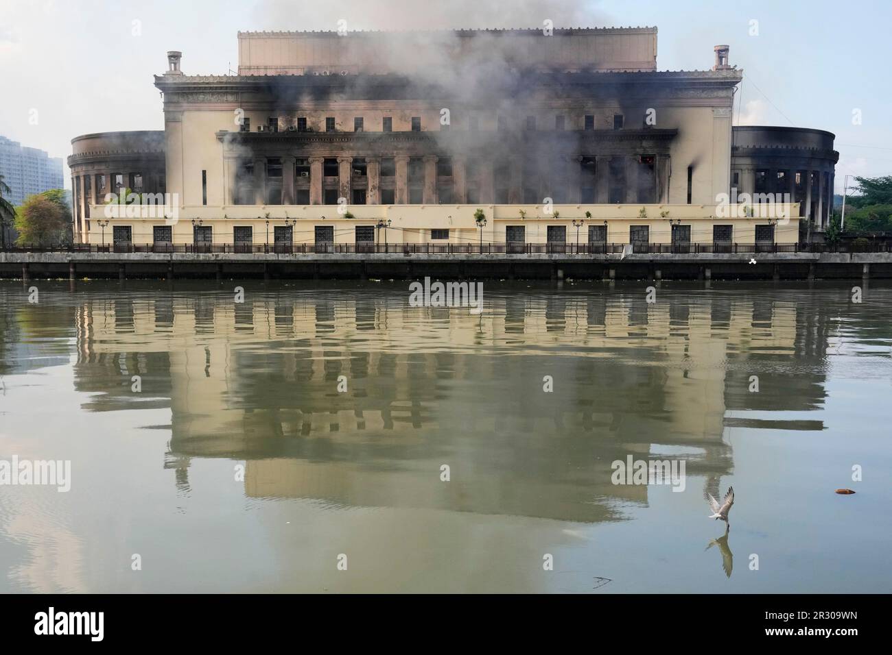 Smoke billows from the still smoldering Manila Central Post Office as a ...