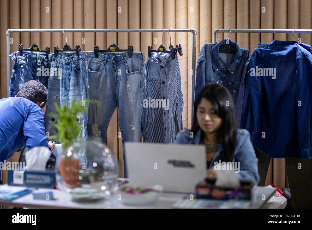 Potential customers browse around a stall at the Bangladesh Denim Expo ...