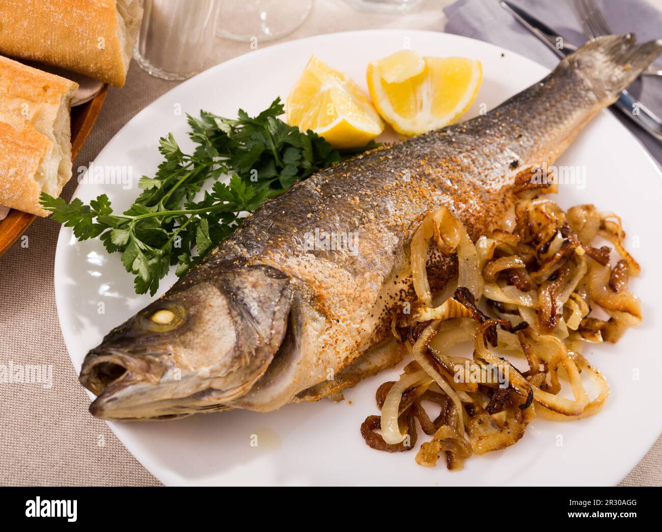 Delicious fish dish - baked sea bass Stock Photo - Alamy