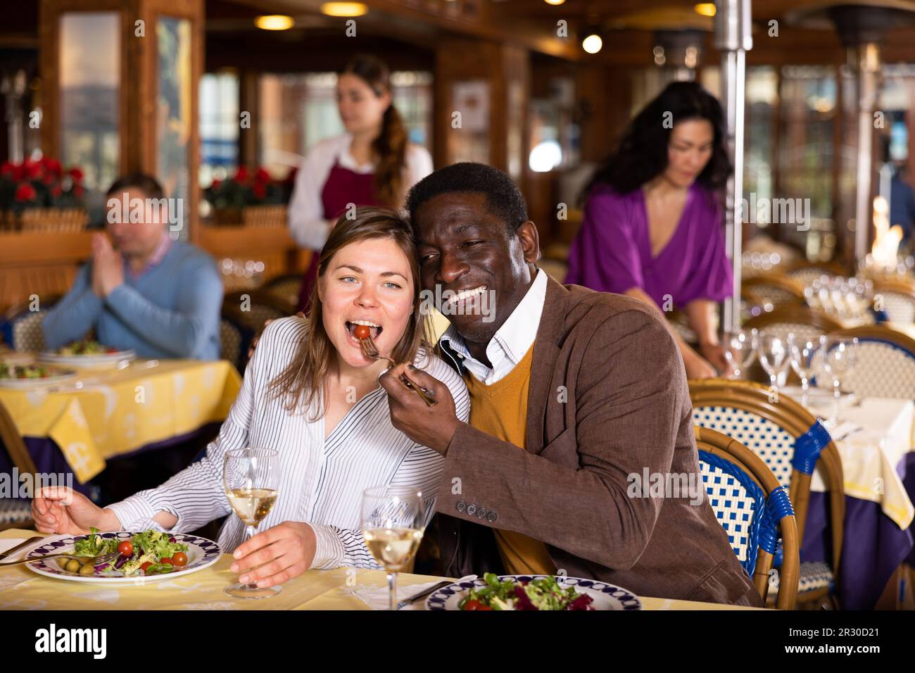 Wife feeding husband dining table hi-res stock photography and images ...