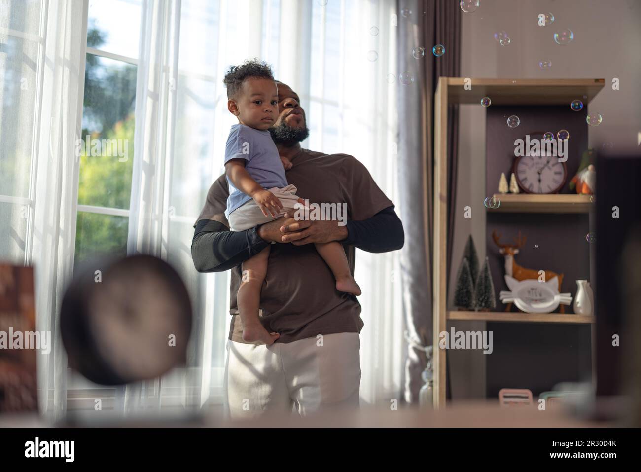 The father embraced and carefully picked up his young son with ...