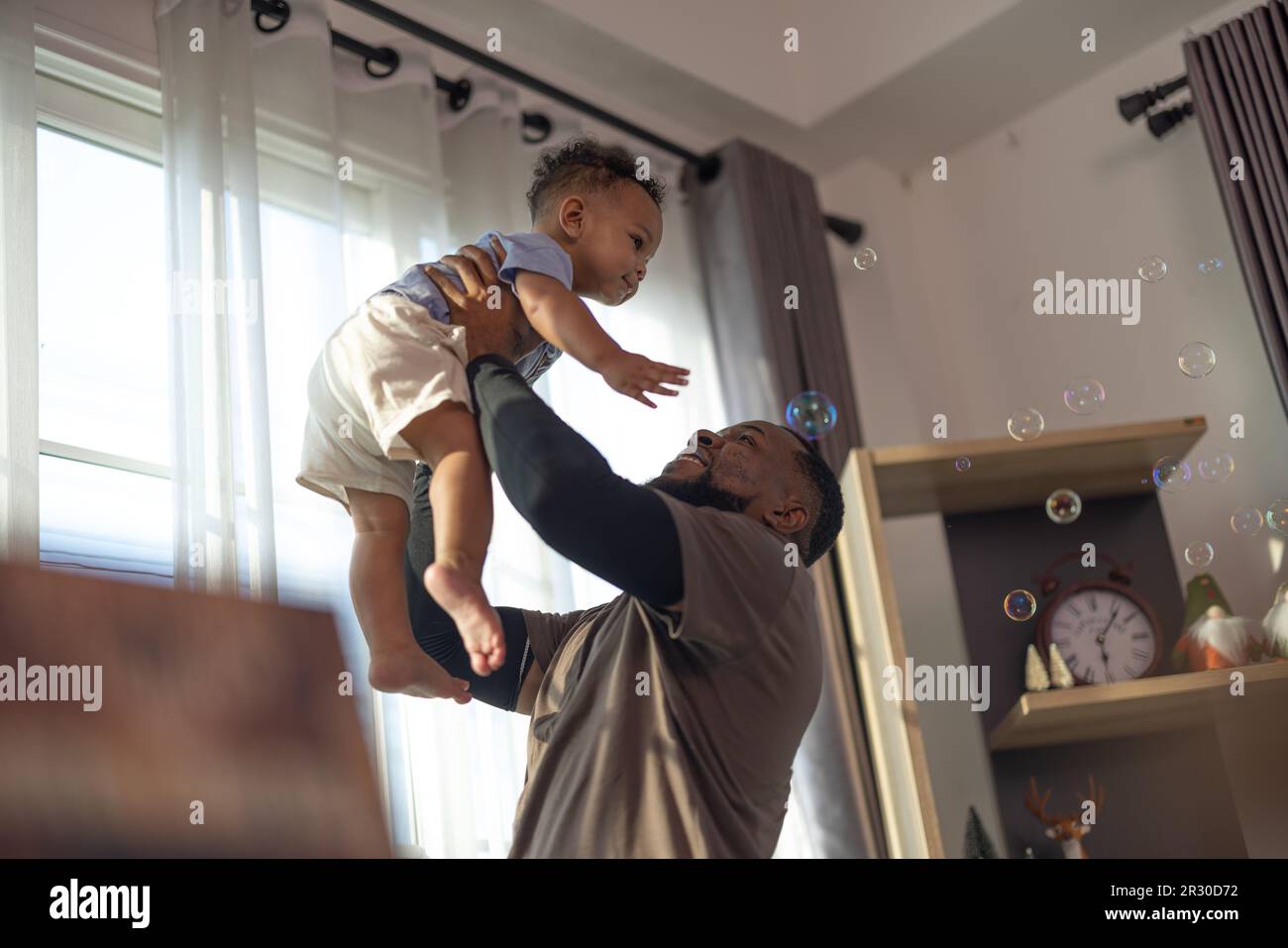 The father embraced and carefully picked up his young son with ...