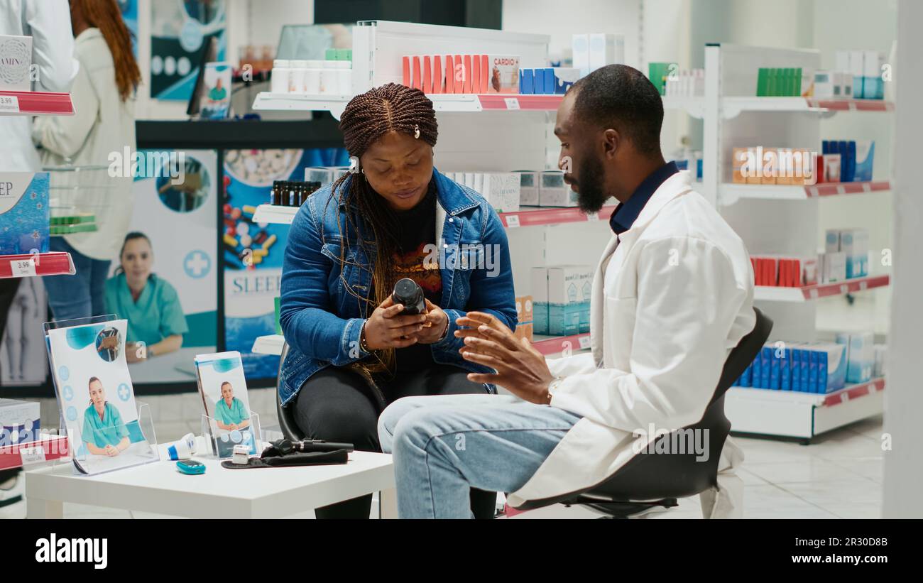 Pharmacy worker recommending medication to woman Stock Photo - Alamy