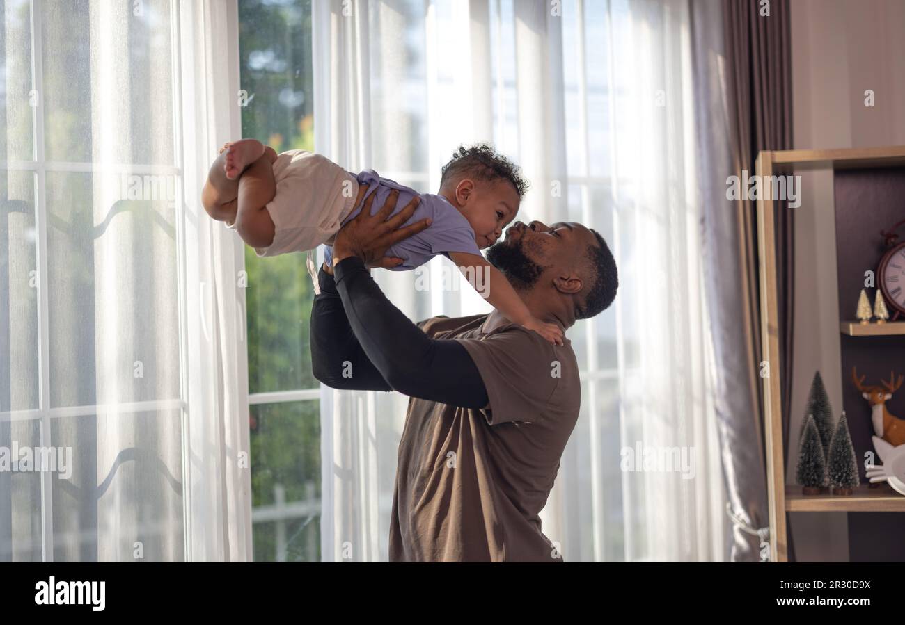 The father embraced and carefully picked up his young son with ...