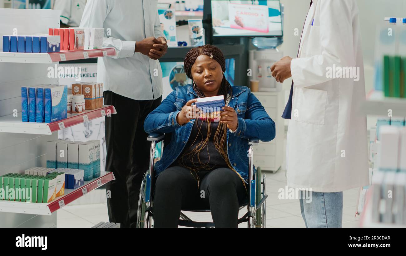 Pharmacy consultant helping client with disability Stock Photo - Alamy