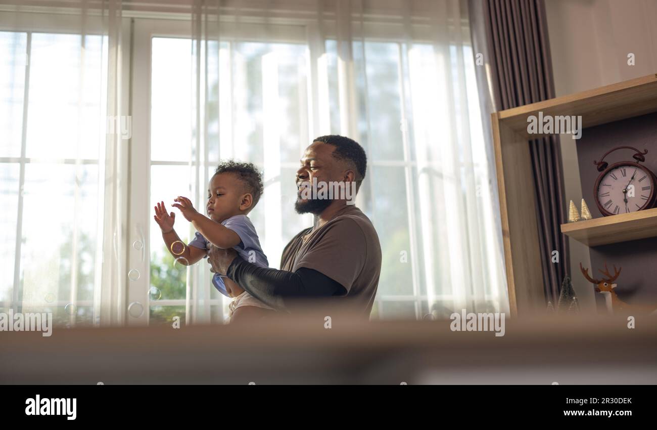 The father embraced and carefully picked up his young son with ...