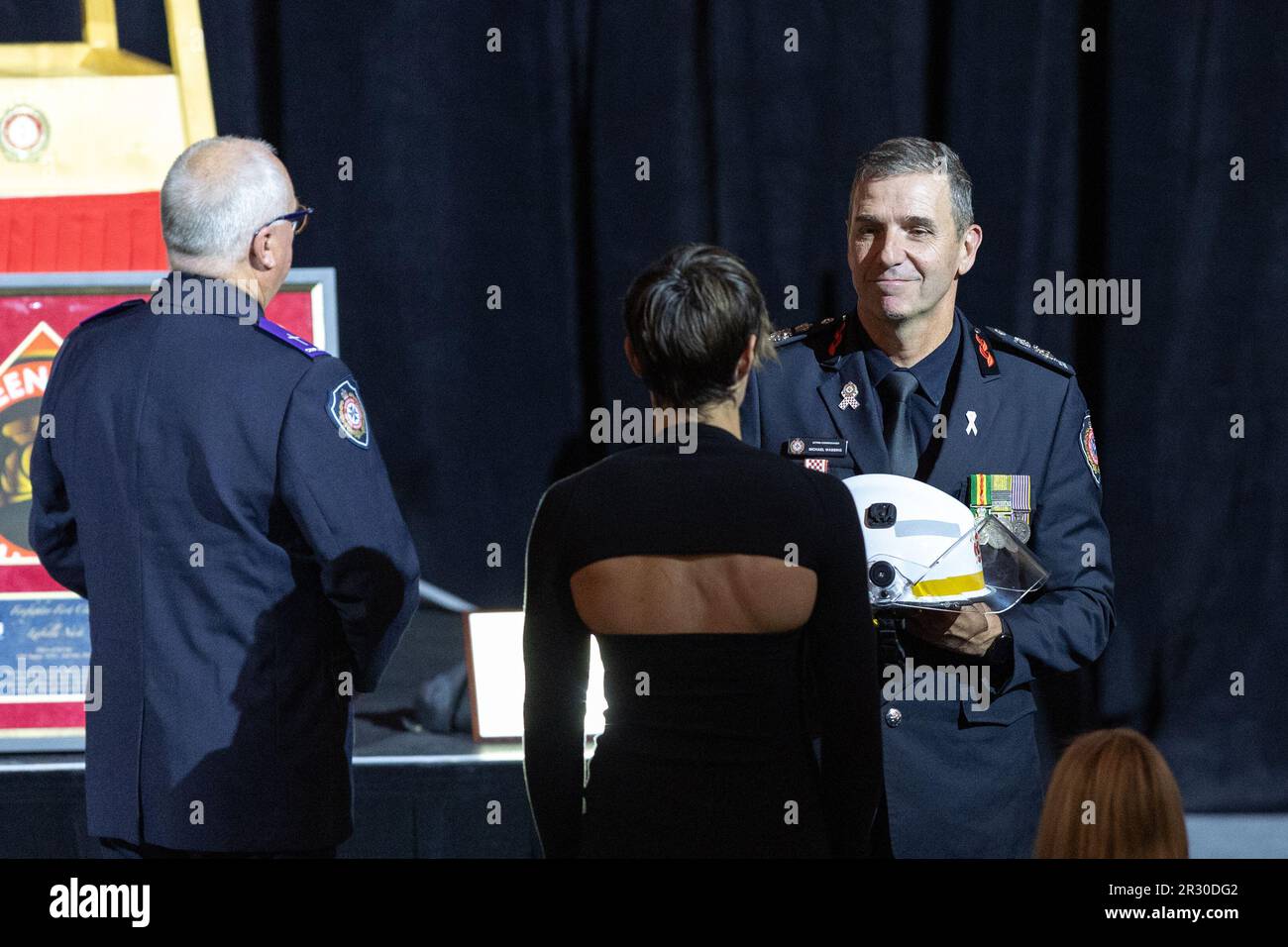 The Commissioner’s presentation of helmet and flag, accompanied by QFES ...
