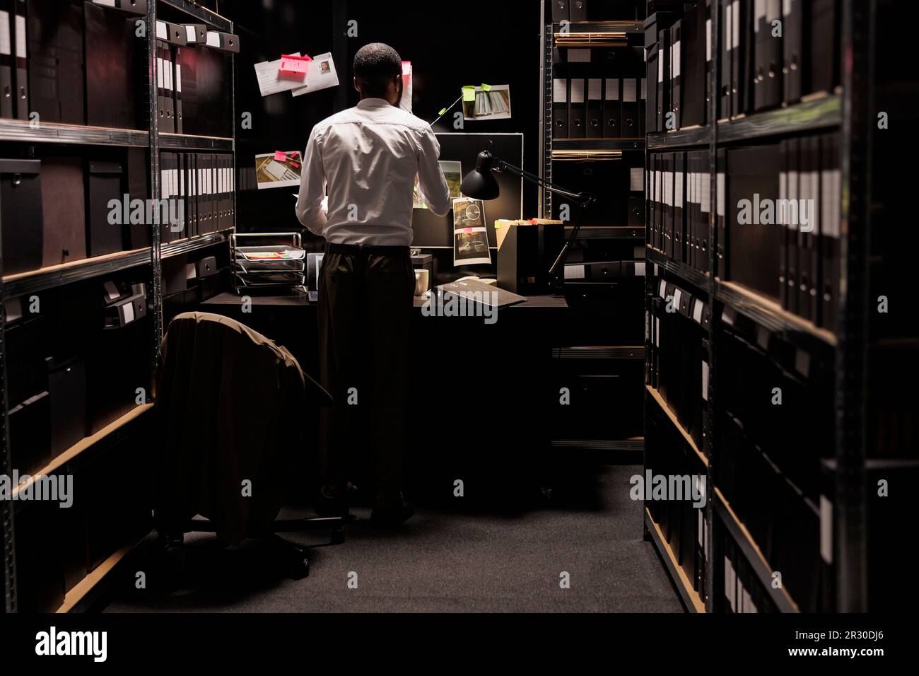 Investigator analyzing detective board, brainstorming to solve crime ...