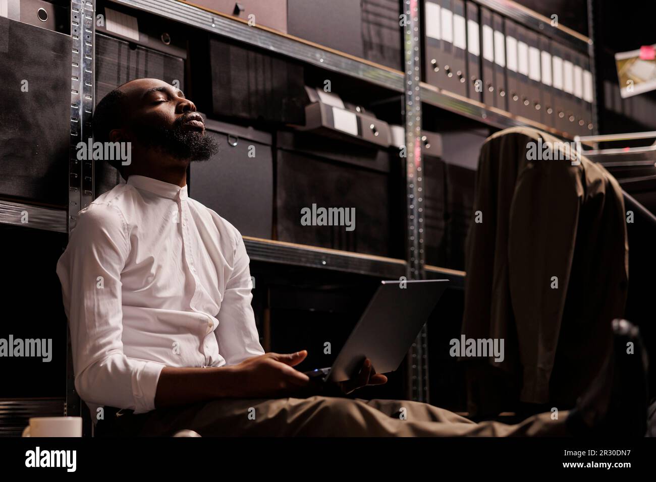 Tired detective sitting on floor thinking about crime solving Stock ...