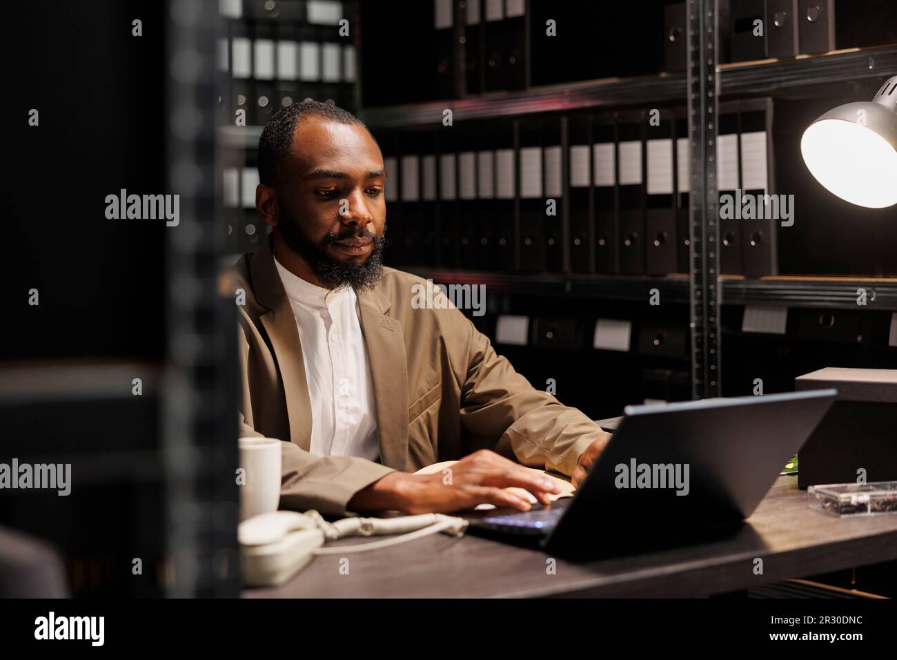 African american man detective conducting investigation using laptop ...
