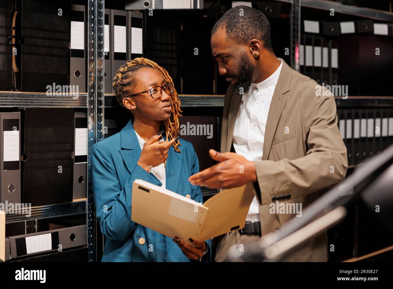 African american detective reading and discussing criminal case file ...