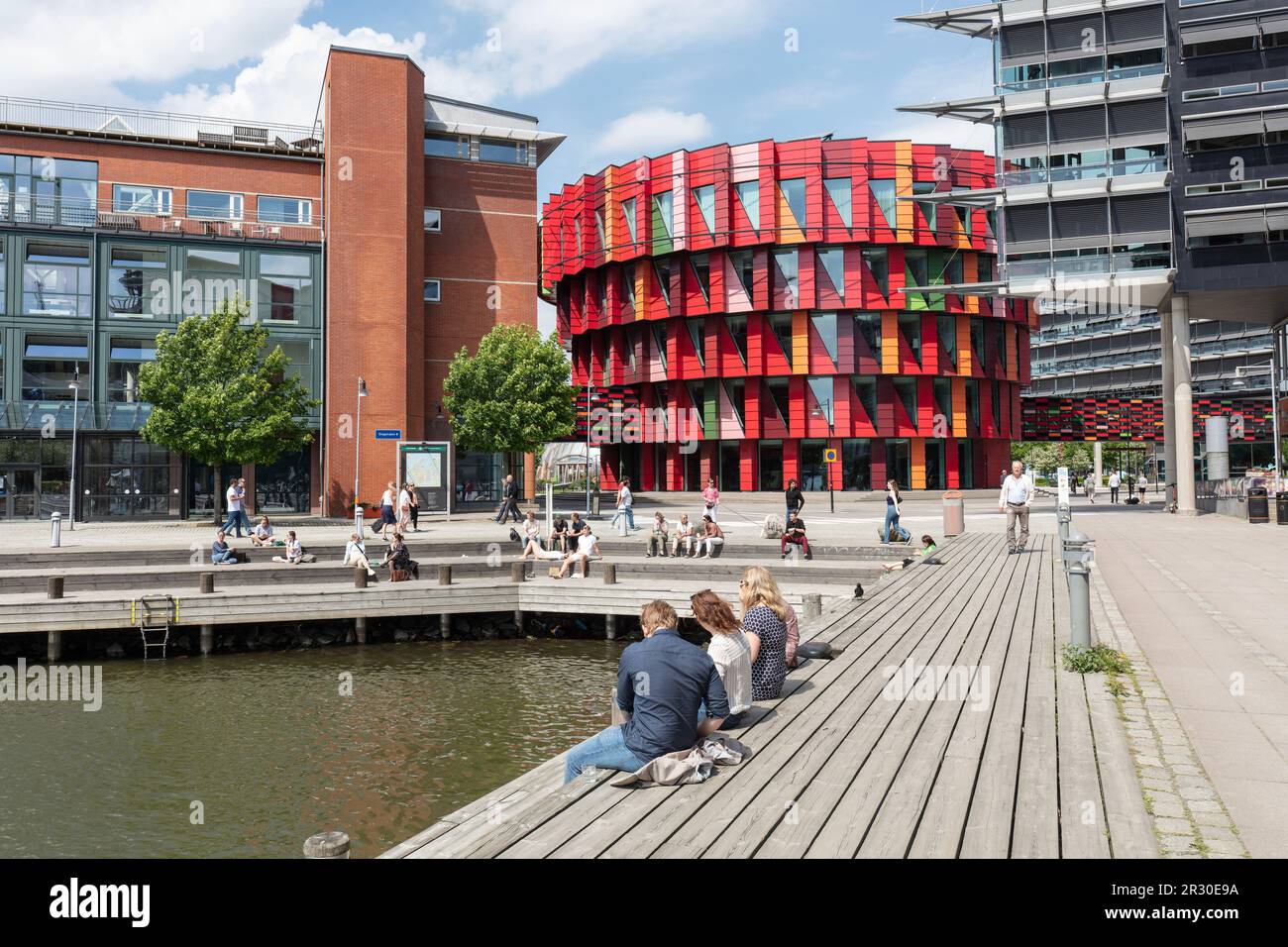 People on pier at Lindoholmspiren by red Kuggan (Cogwheel) building, Chalmer's University of ...