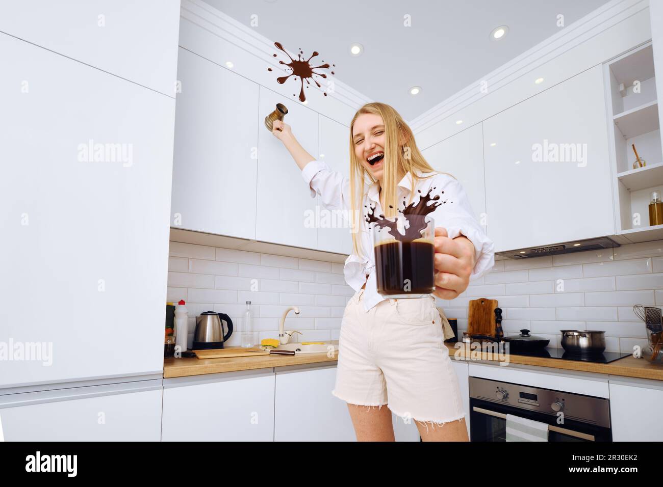 Crazy woman dancing and screaming with cup of coffee in hand in the ...