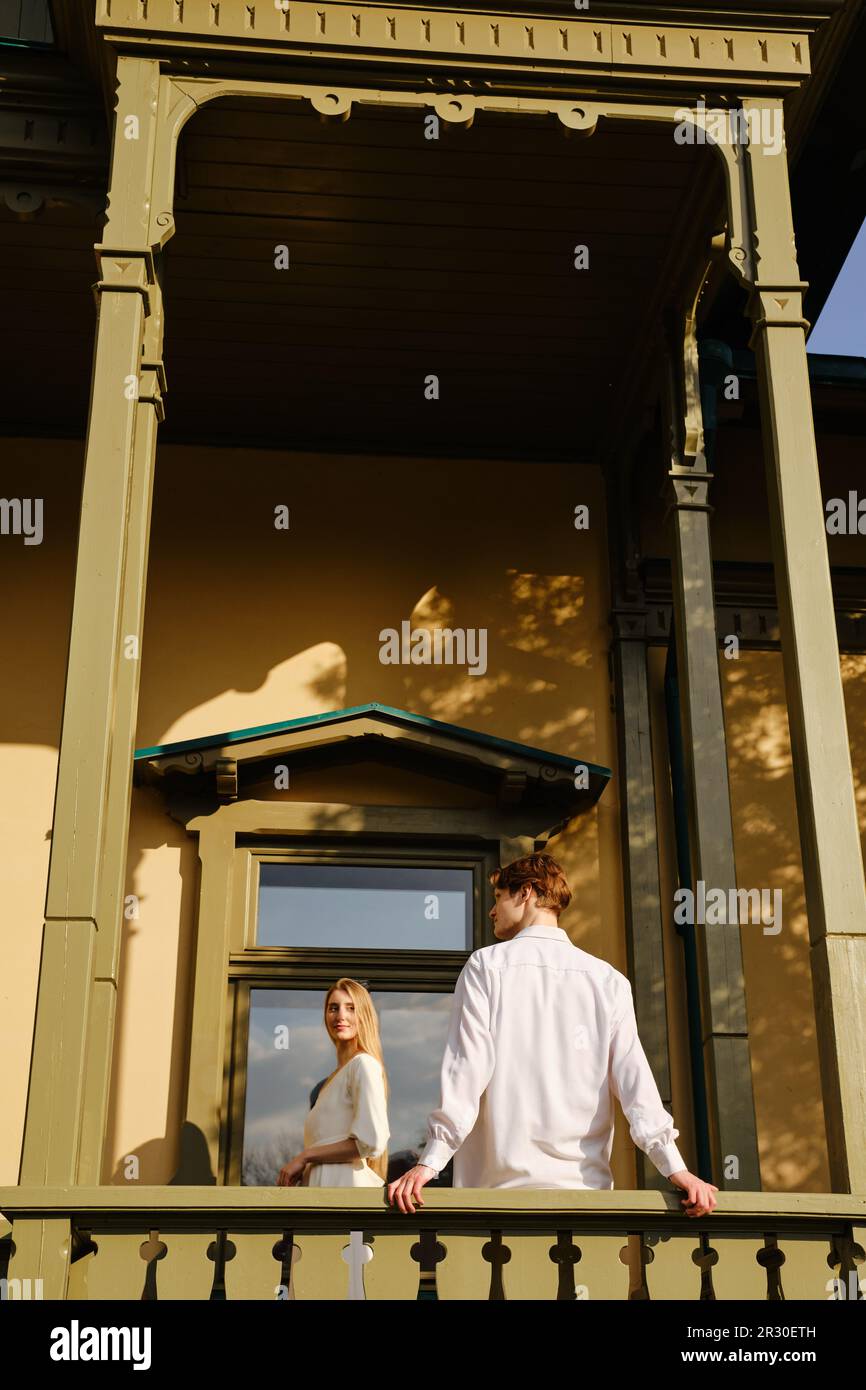 Romantic and stylish couple in love posing on balcony Stock Photo - Alamy