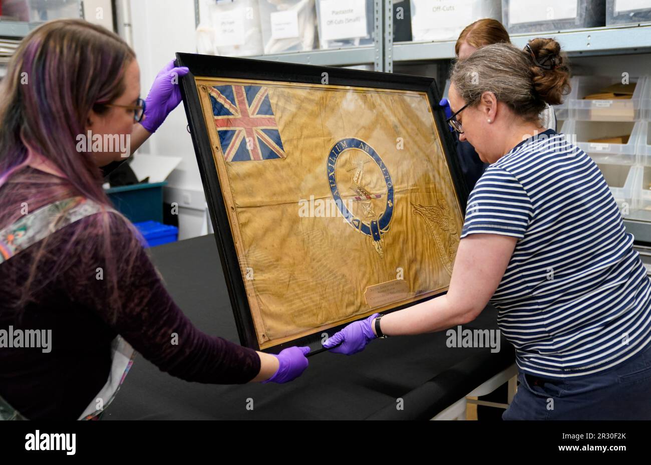 Conservators from the National Museum of the Royal Navy place the ...