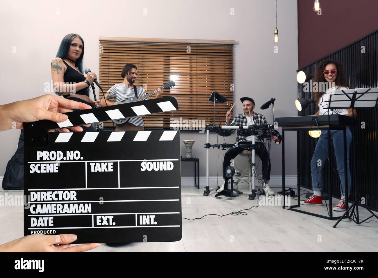 Shooting movie. Second assistant camera holding clapperboard in front ...