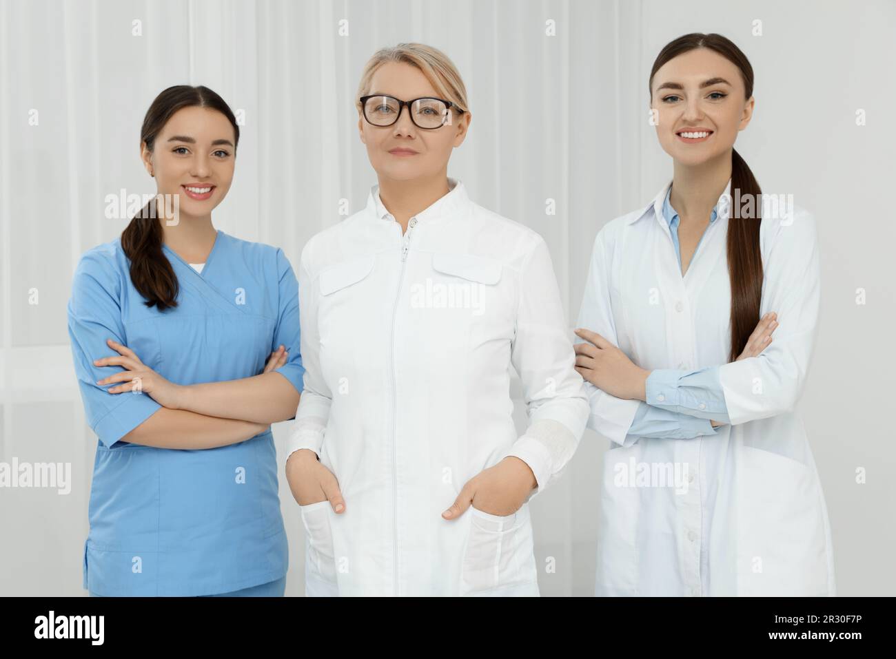 Portrait of medical doctors wearing uniforms indoors Stock Photo - Alamy