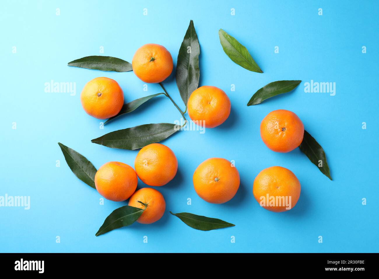 Fresh ripe tangerines on light blue background, flat lay Stock Photo ...