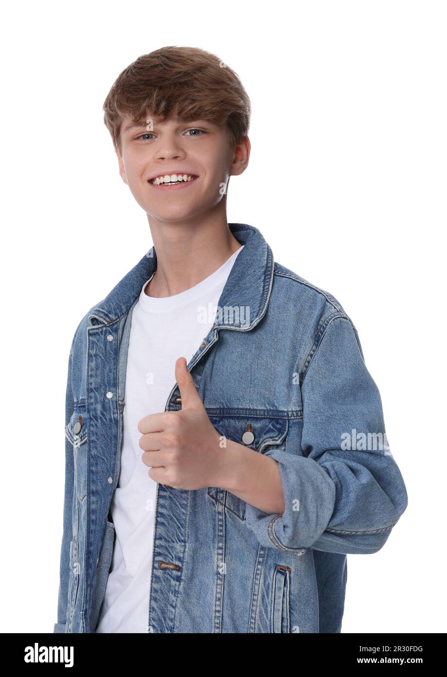 Teenage boy showing thumb up on white background Stock Photo - Alamy