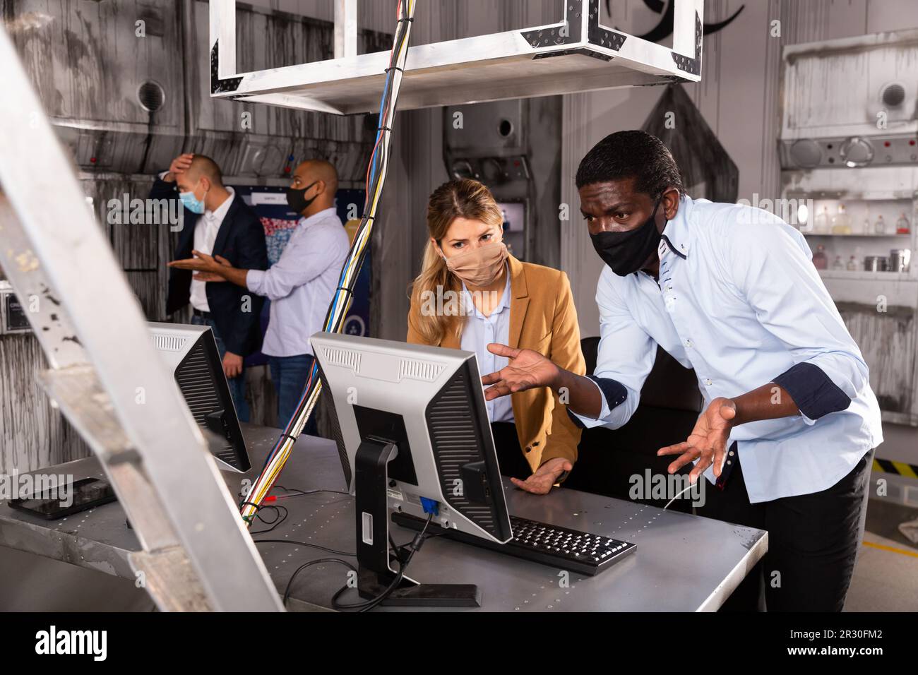 Young people solving conundrum in escape room Stock Photo - Alamy