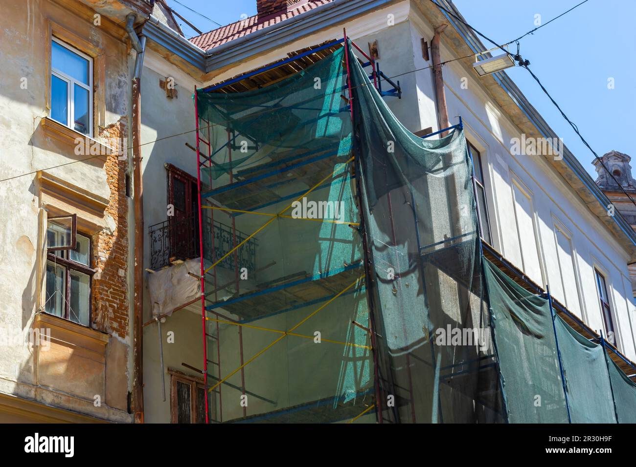 Restoration of the building. Scaffolding and protective green building ...