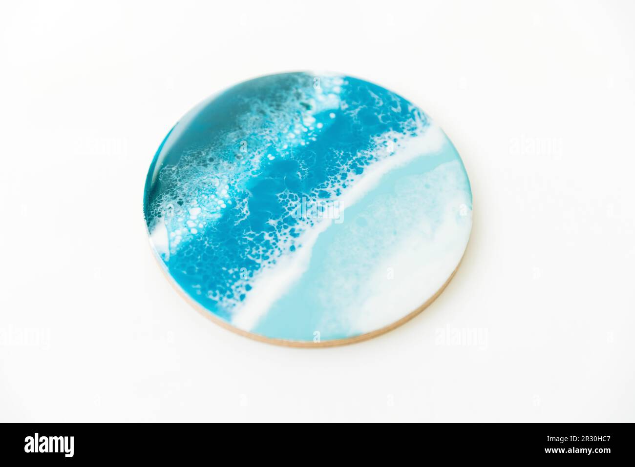 Resin art epoxy composition with blue colors and stones on white ...