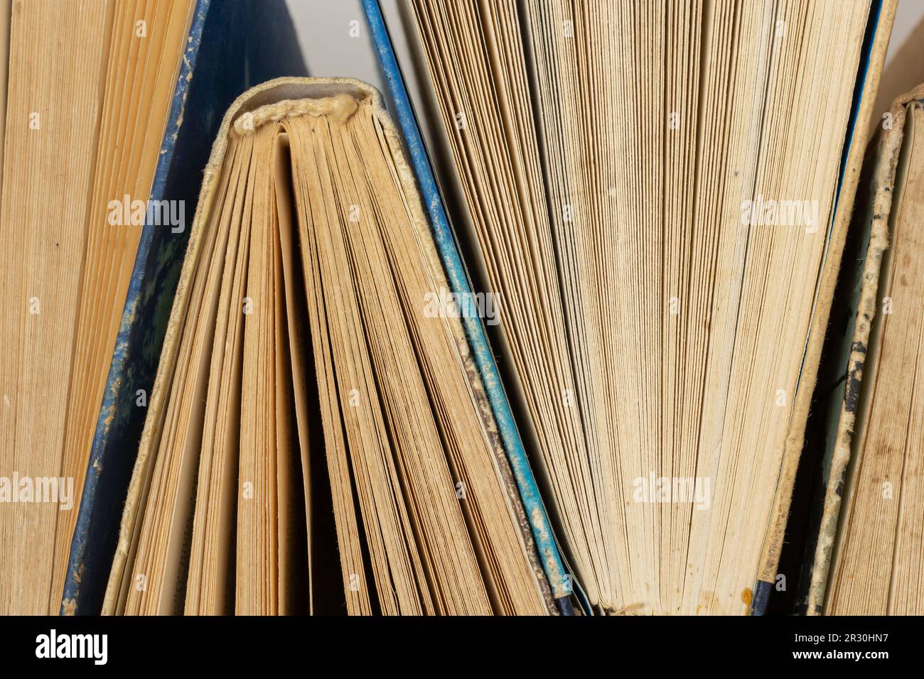Book background. Stack of books in the library. Old yellow pages of ...