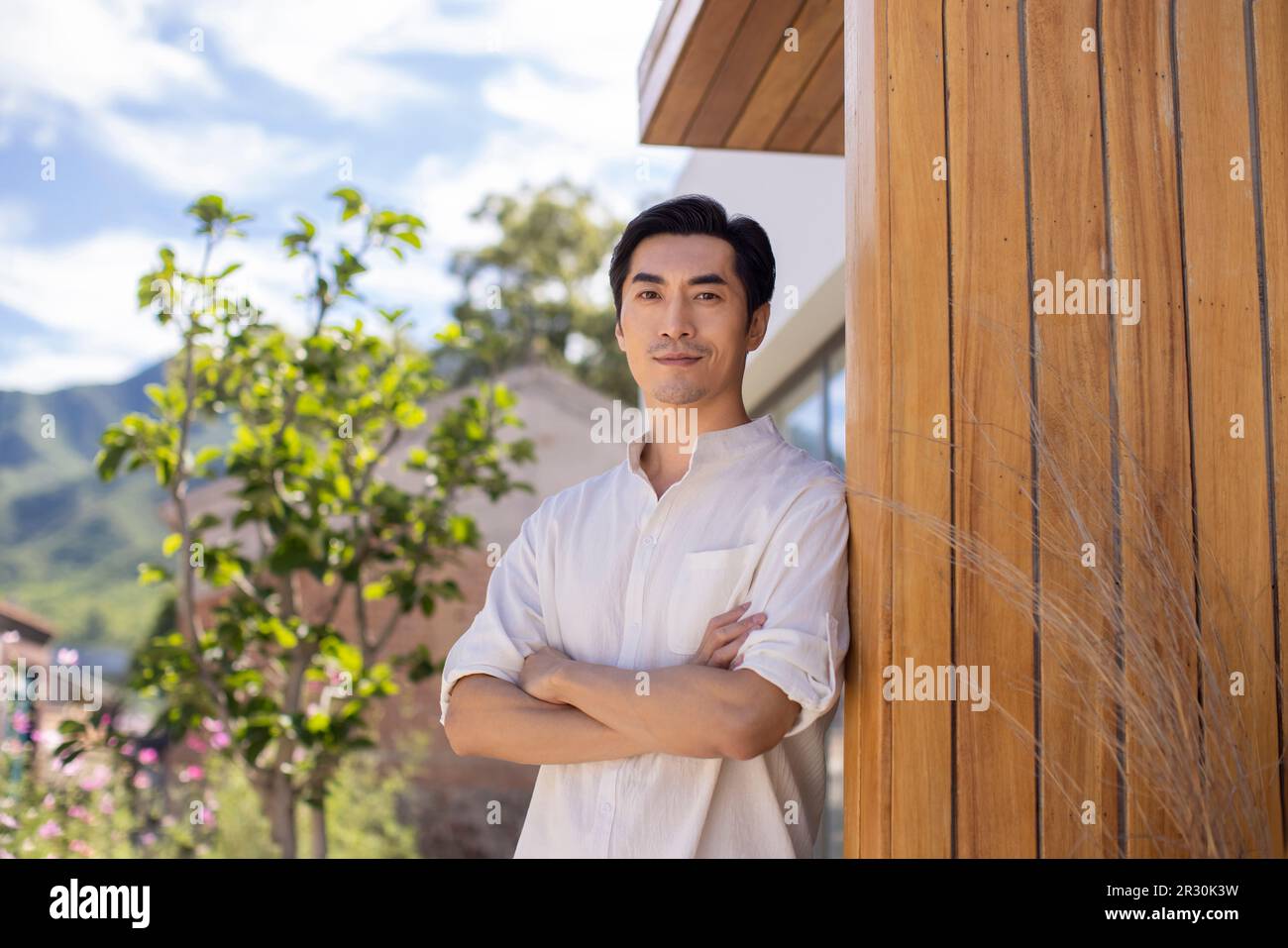 Happy mid adult Chinese man on vacation Stock Photo - Alamy