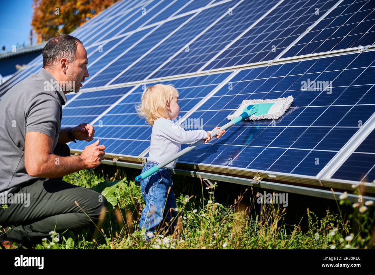 Father showing his little son the solar panels during sunny day. Cute ...