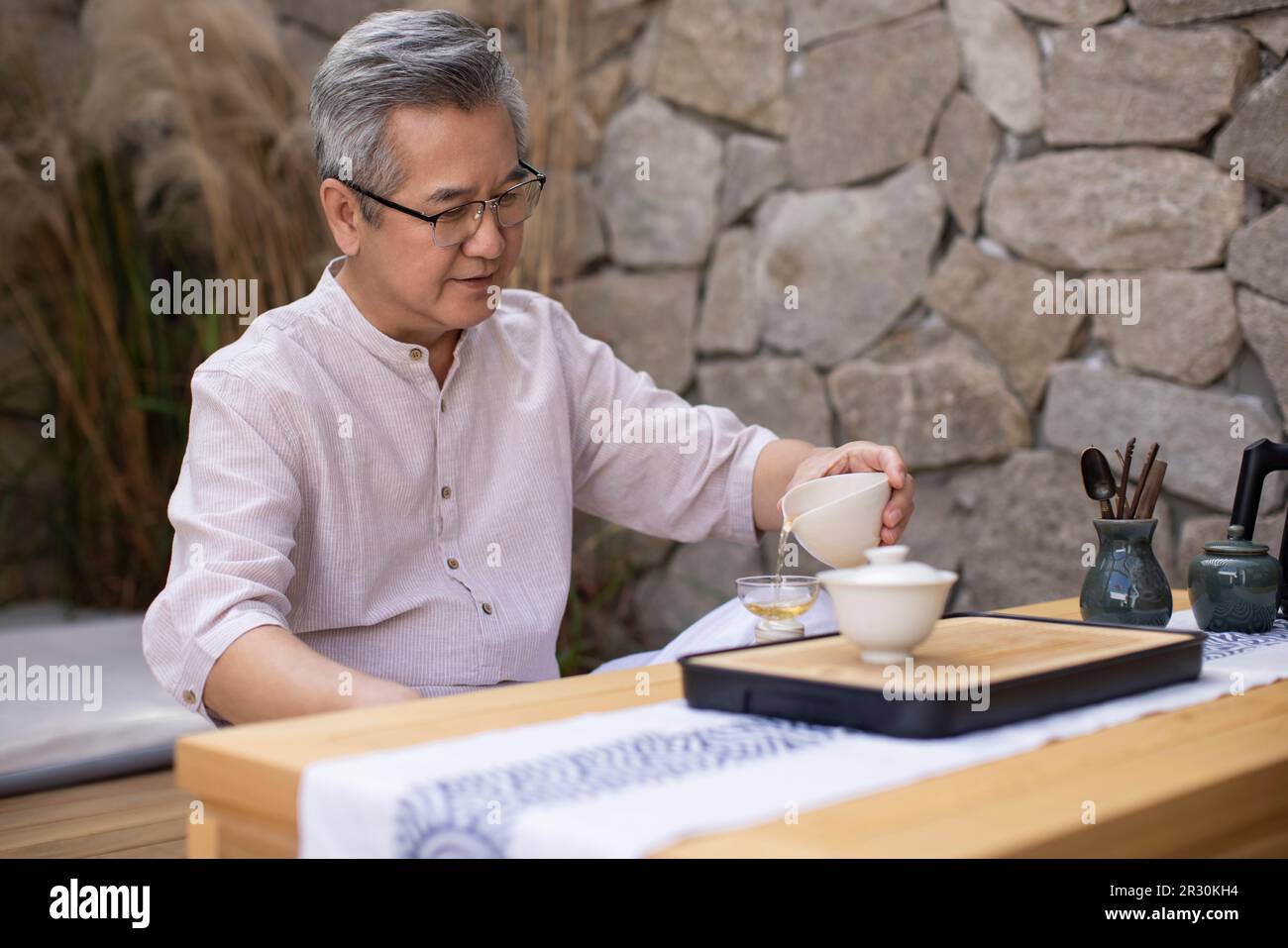 Mature Chinese man drinking tea in tea room Stock Photo - Alamy