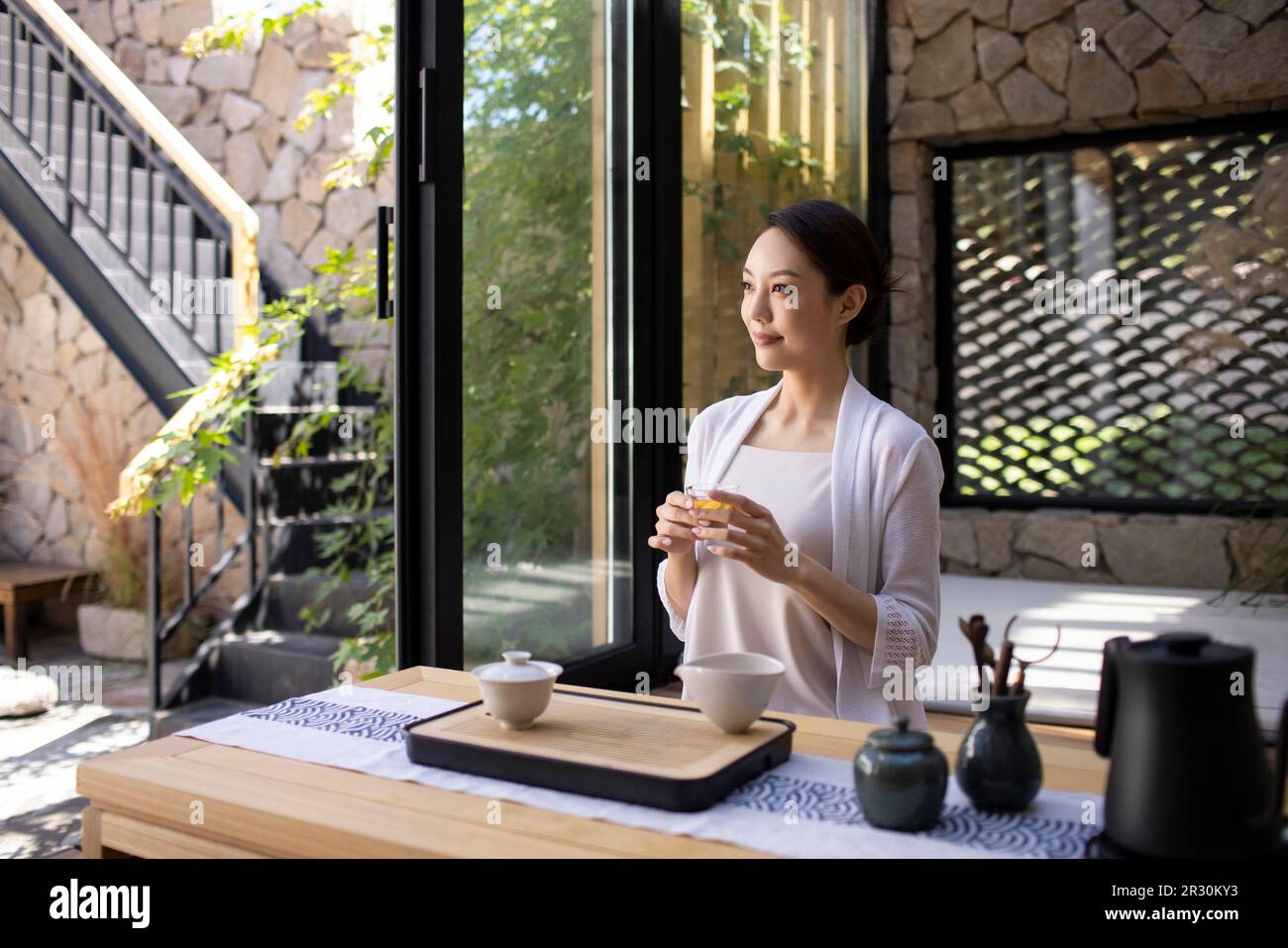 Elegant young Chinese woman drinking tea in tea room Stock Photo - Alamy