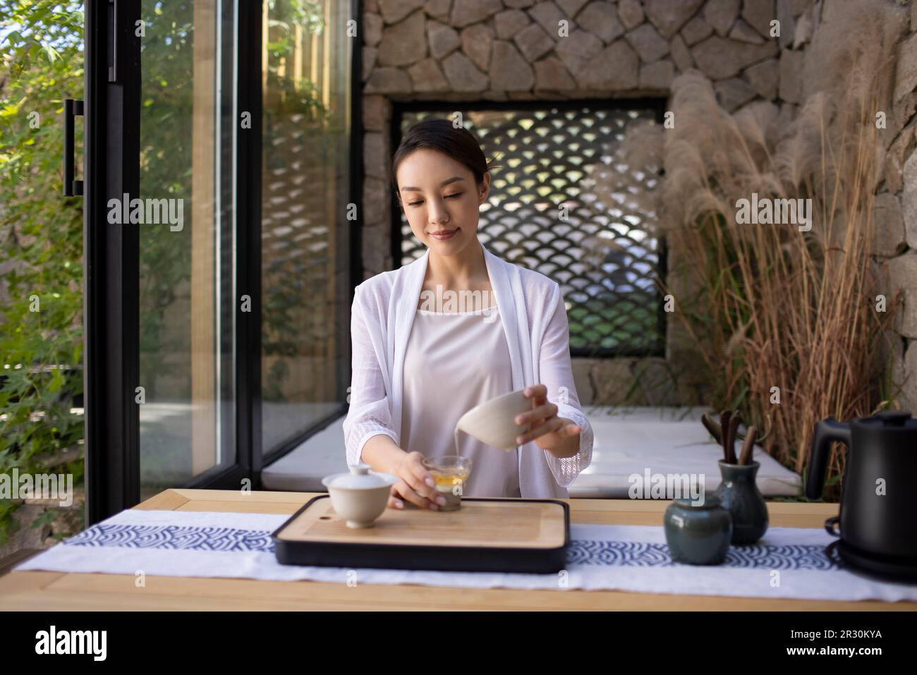 Elegant young Chinese woman drinking tea in tea room Stock Photo - Alamy